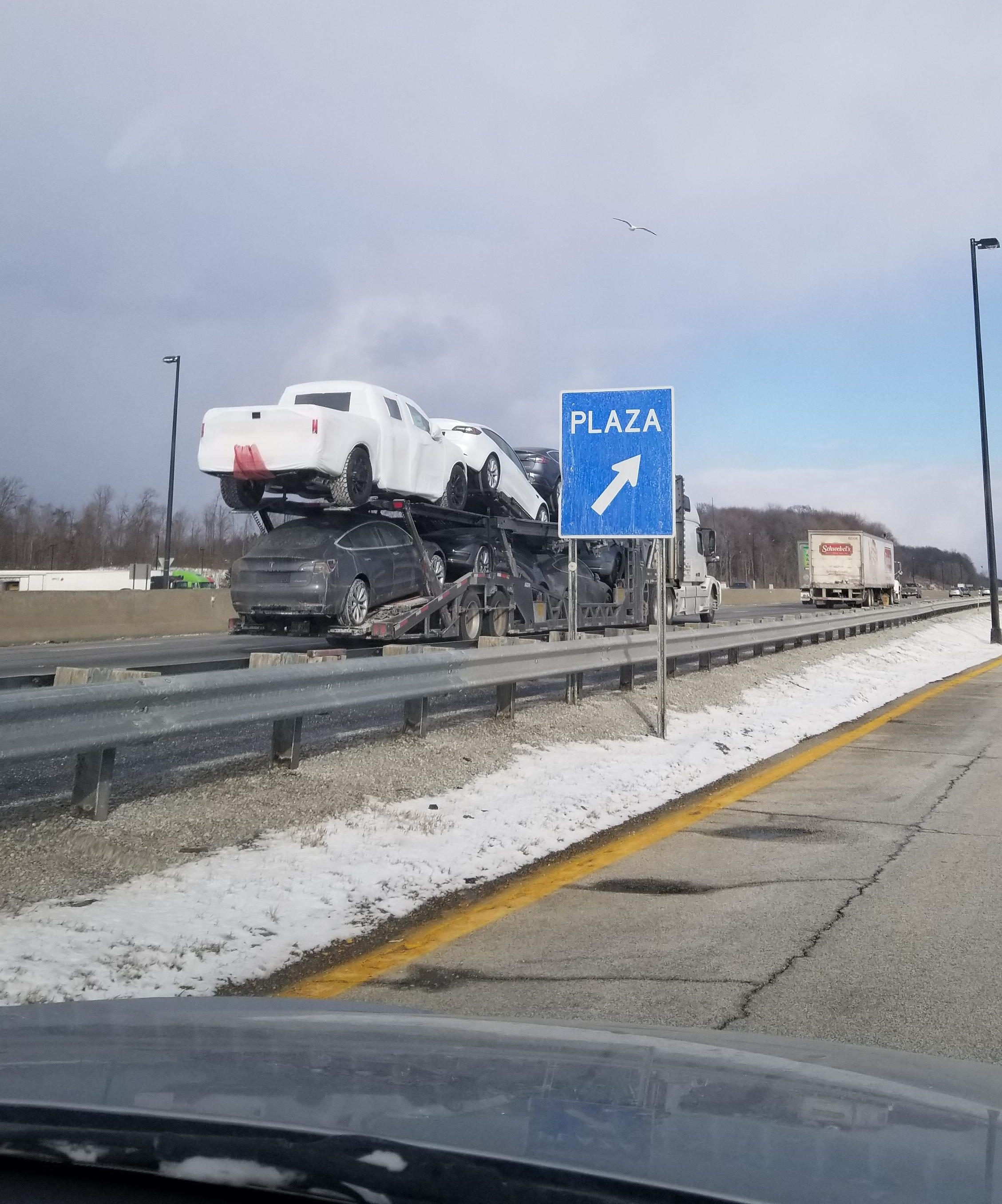Tesla carrier spotted transporting a wrapped pickup truck, sparks ...