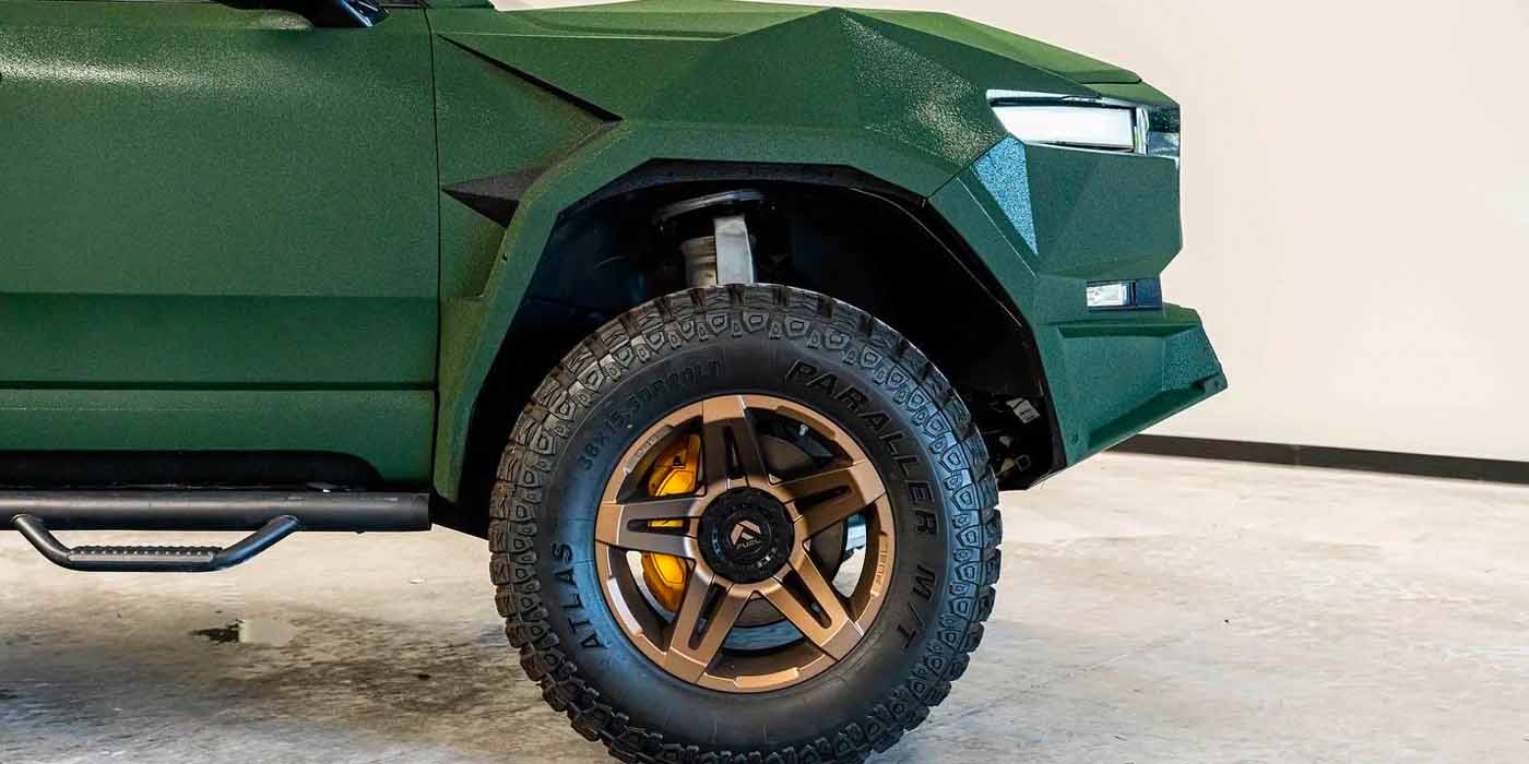 This custom Rivian has been fit with a lift kit, kevlar paint, roll cage